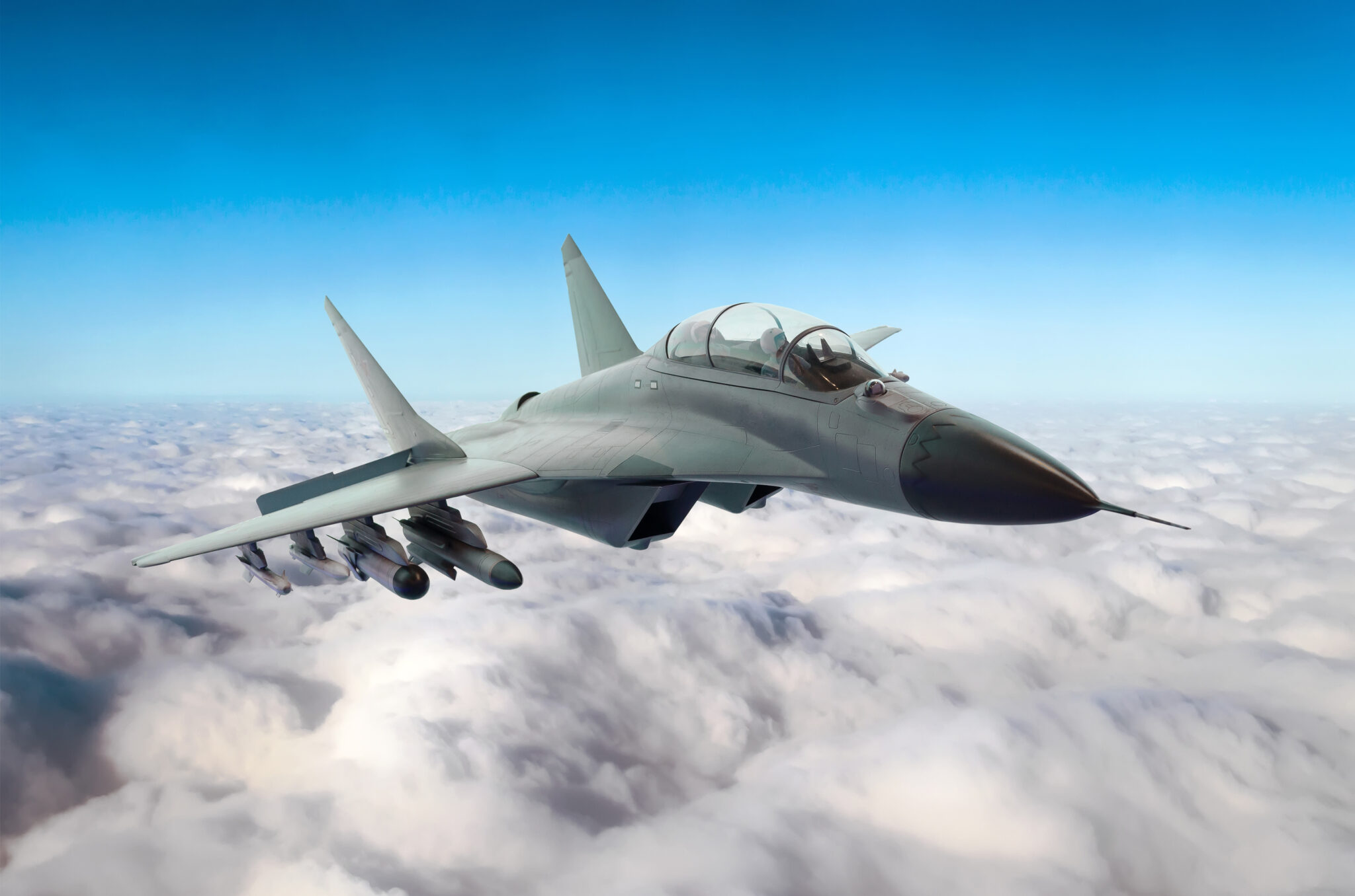Military fighter jet flies in the sky above the clouds. | Ultramain Systems